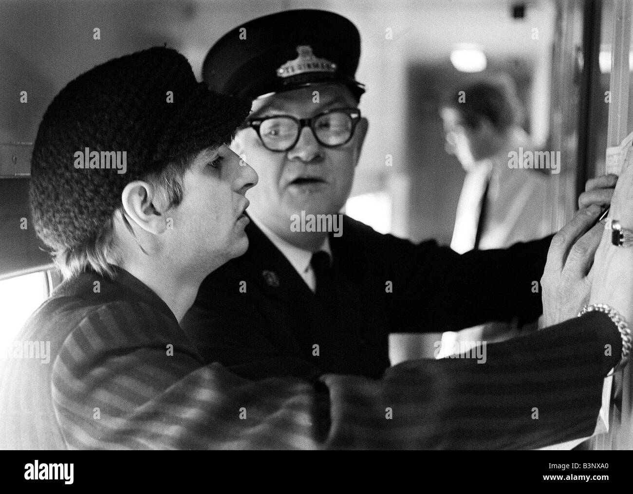 The Beatles February 1964 Ringo Starr with train conductor checking the ...