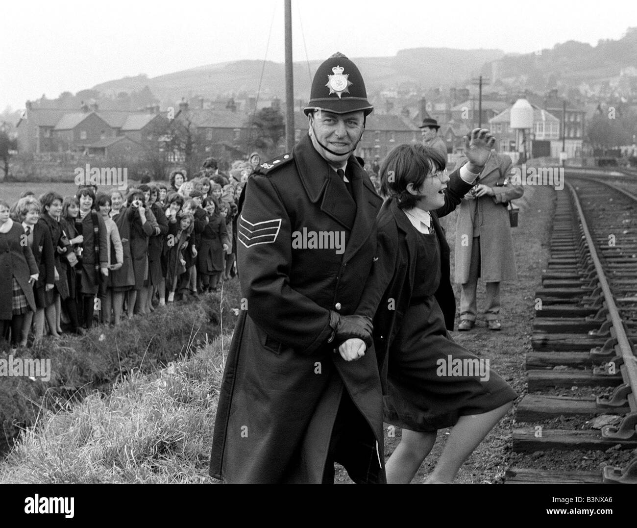 The Beatles March 1964 A policeman escorts away school children try to ...
