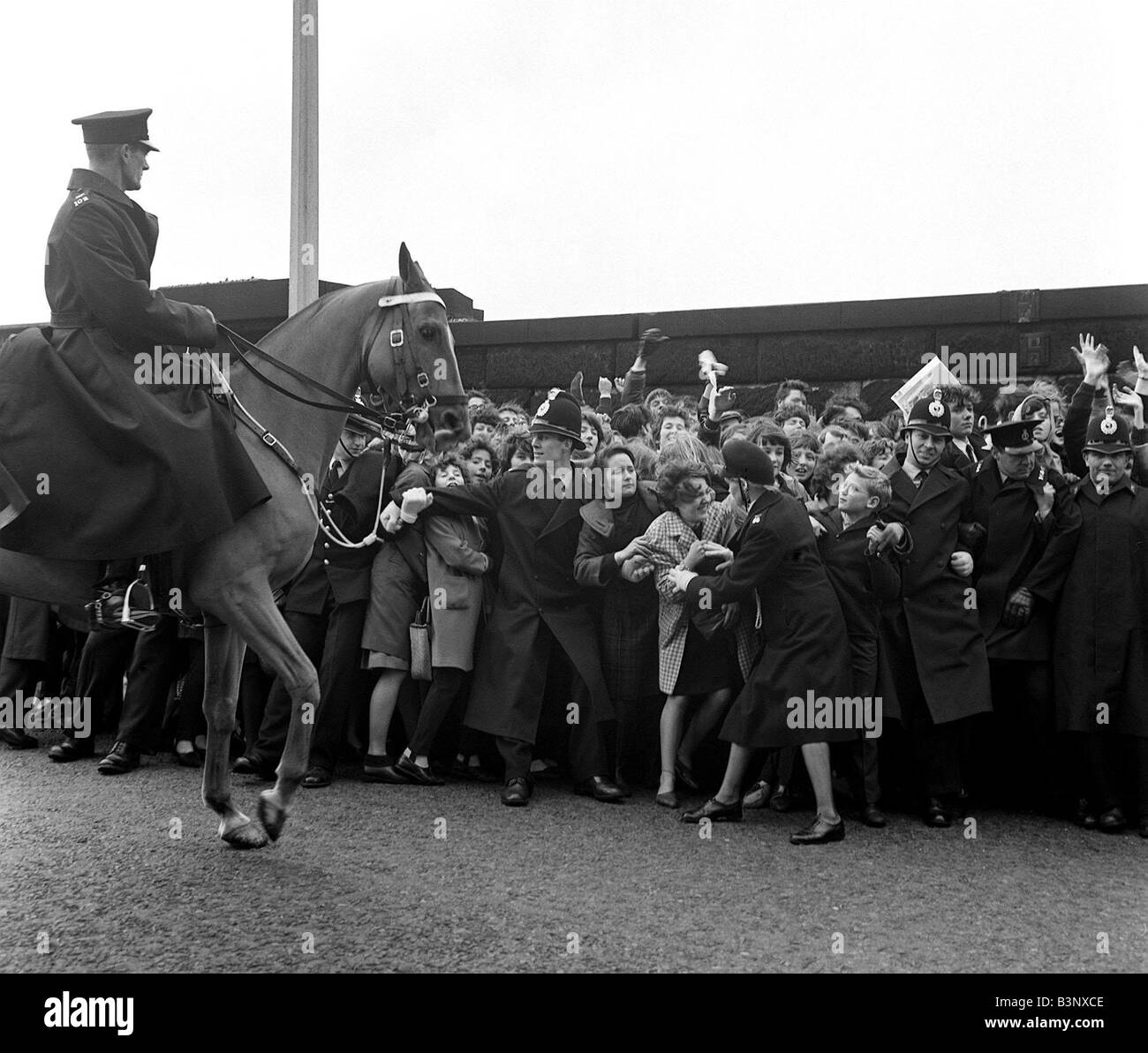 The Beatles November 1963 Policemen and women help to push the ...