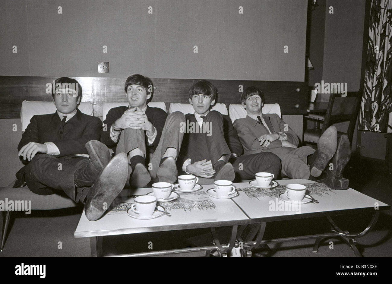 The Beatles relax in their dressing room between the rehearsals for the ...