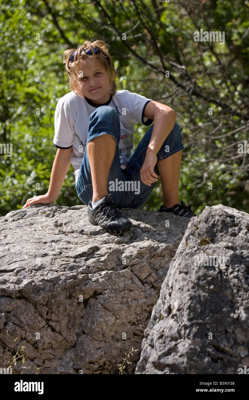 Boy teen sitting on a rocks Stock Photo - Alamy