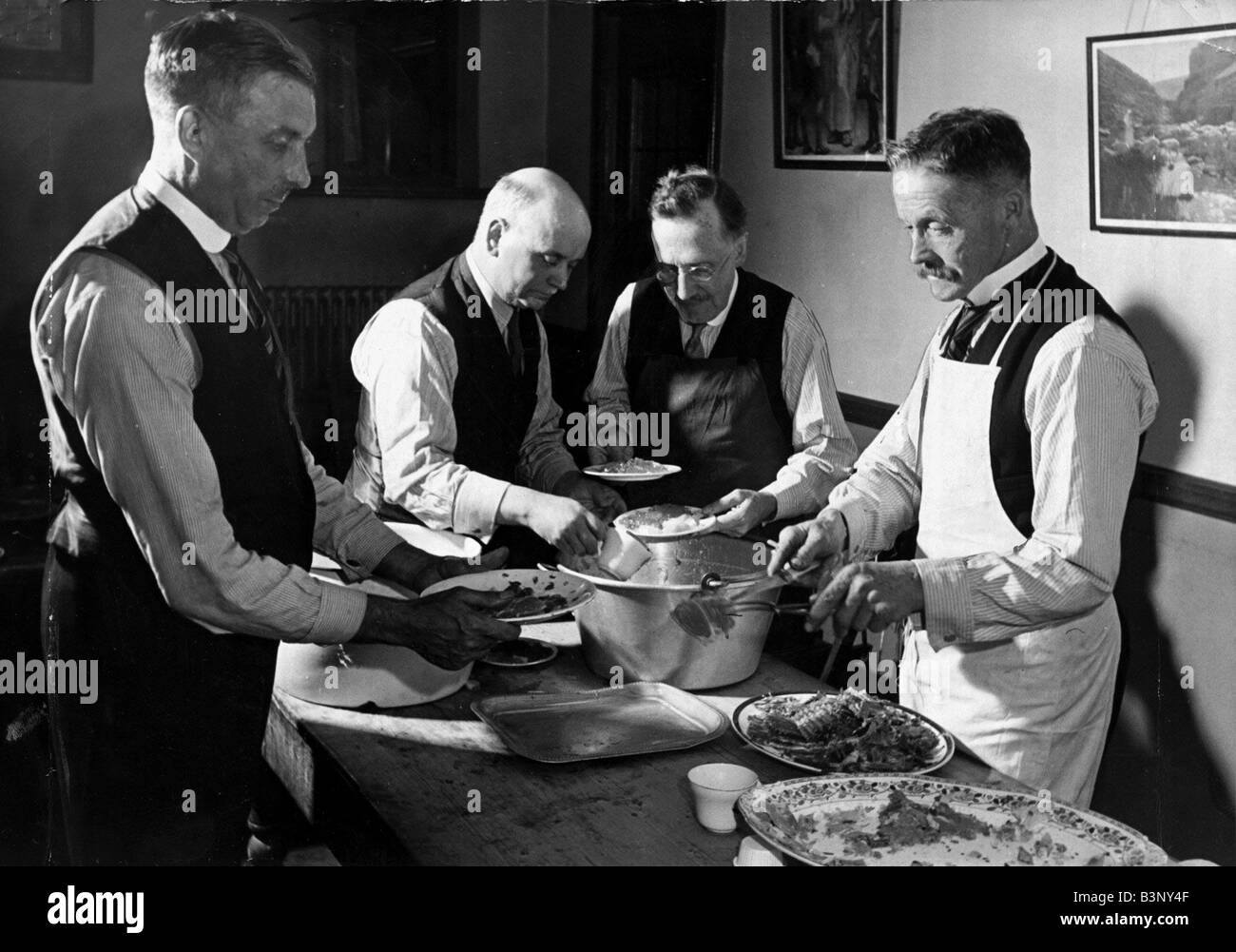 Group of men cooking Black and White Stock Photos & Images - Alamy