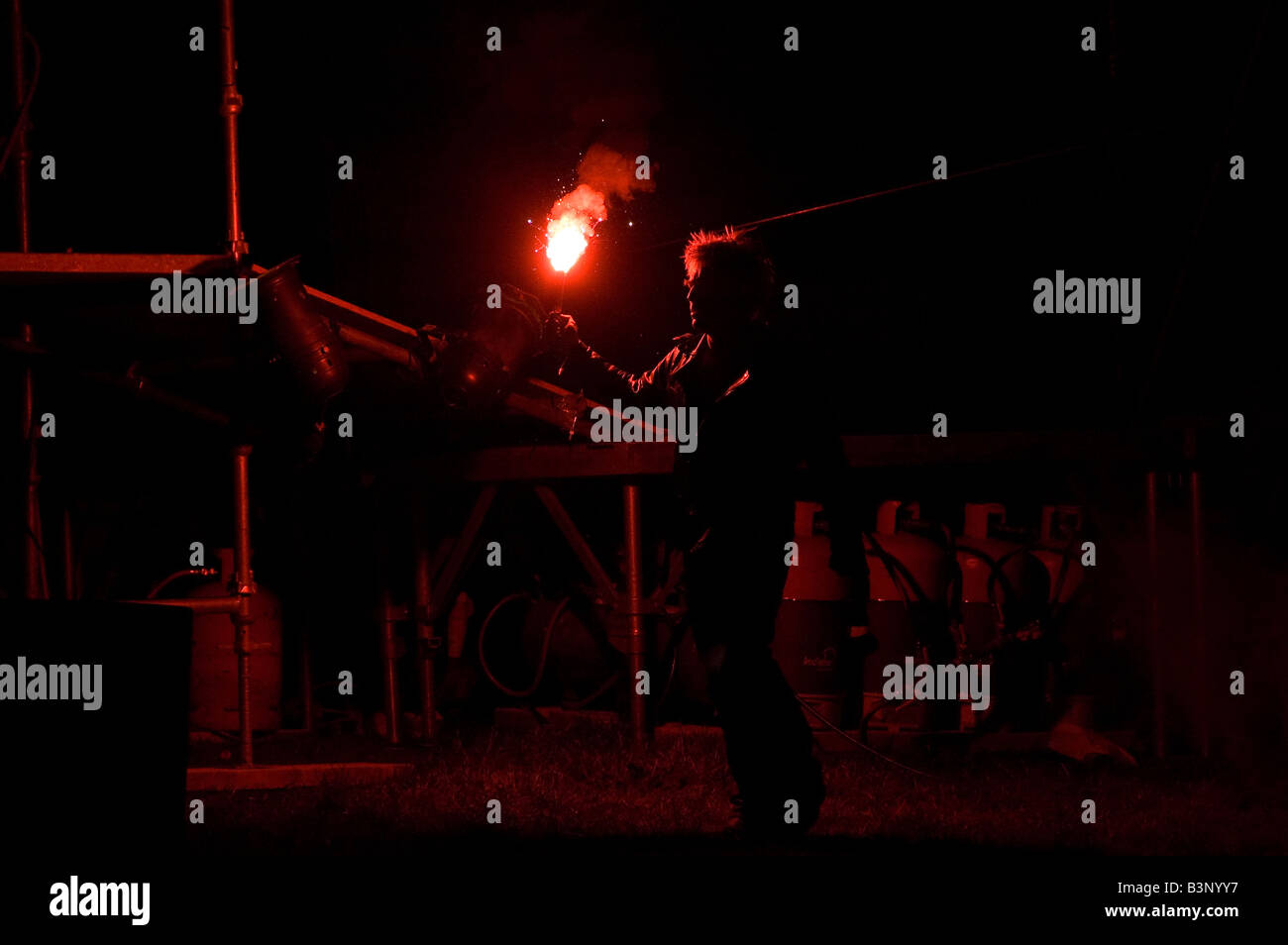 Circus performer holding flare Stock Photo - Alamy