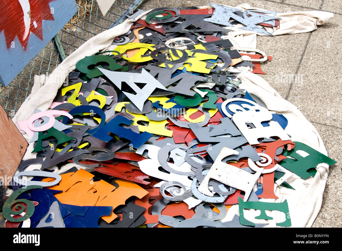 Unordered pile of letters and numbers on a sidewalk Stock Photo - Alamy