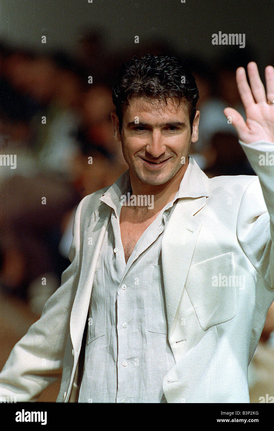 Eric Cantona models at Paco Rabanne show waving to public whilst on ...