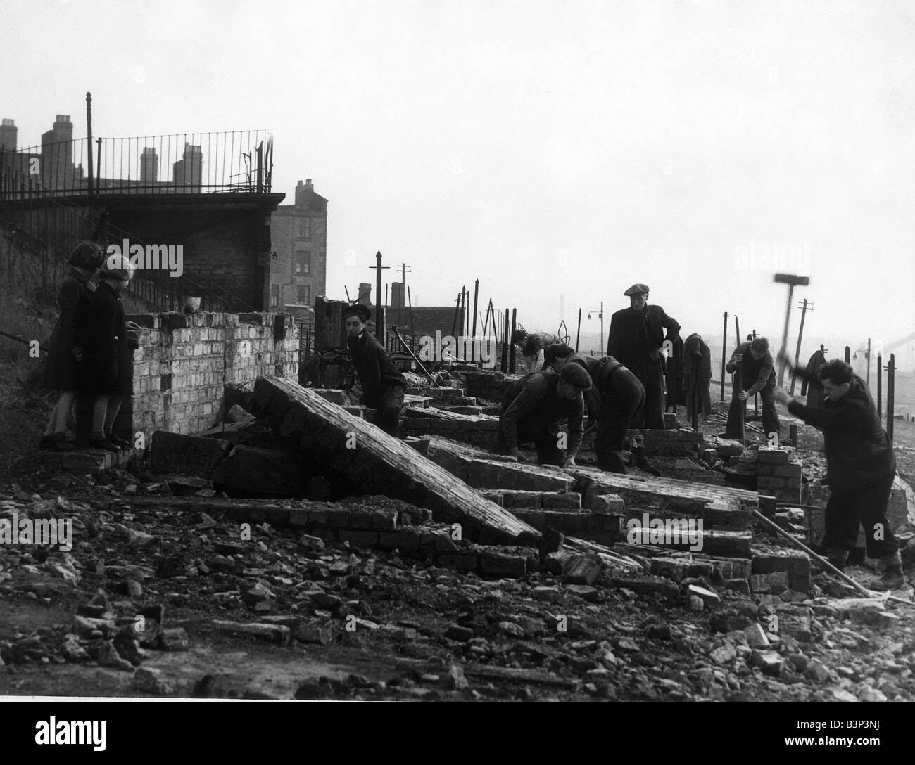 WW2 II Scotland Glasgow Clydebank Air Raid Two children watch workmen ...