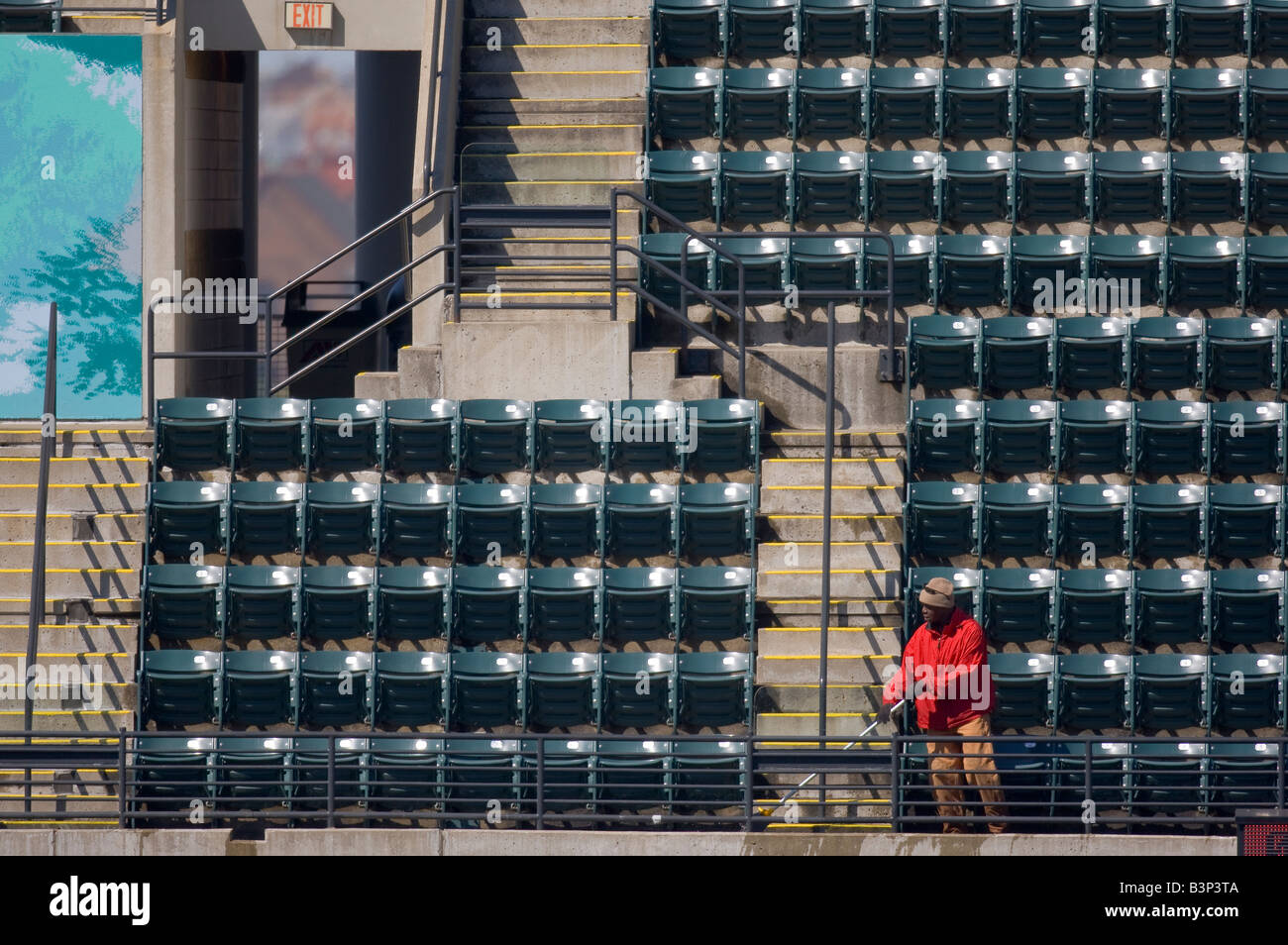 Worker cleaning seats at a stadium Stock Photo - Alamy