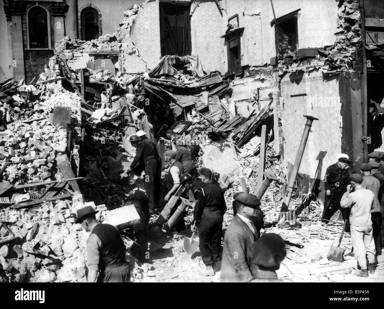 WW2 Air Raid Damage Bomb damage in Cardiff people survey the wreckage ...