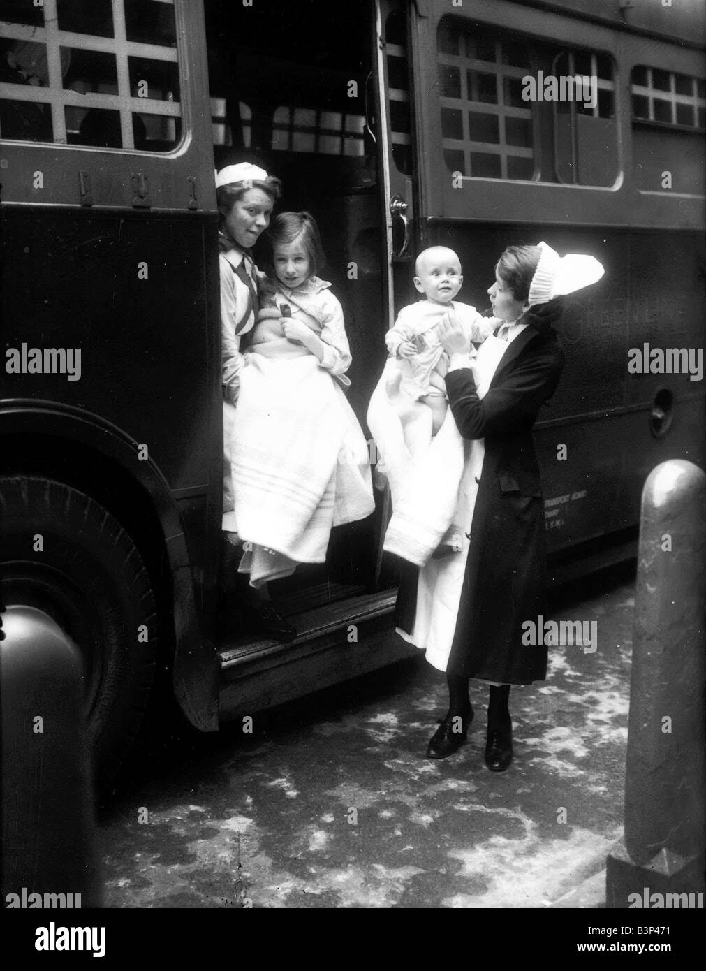 WW2 Nurses carrying little children off the bus during the war Stock ...