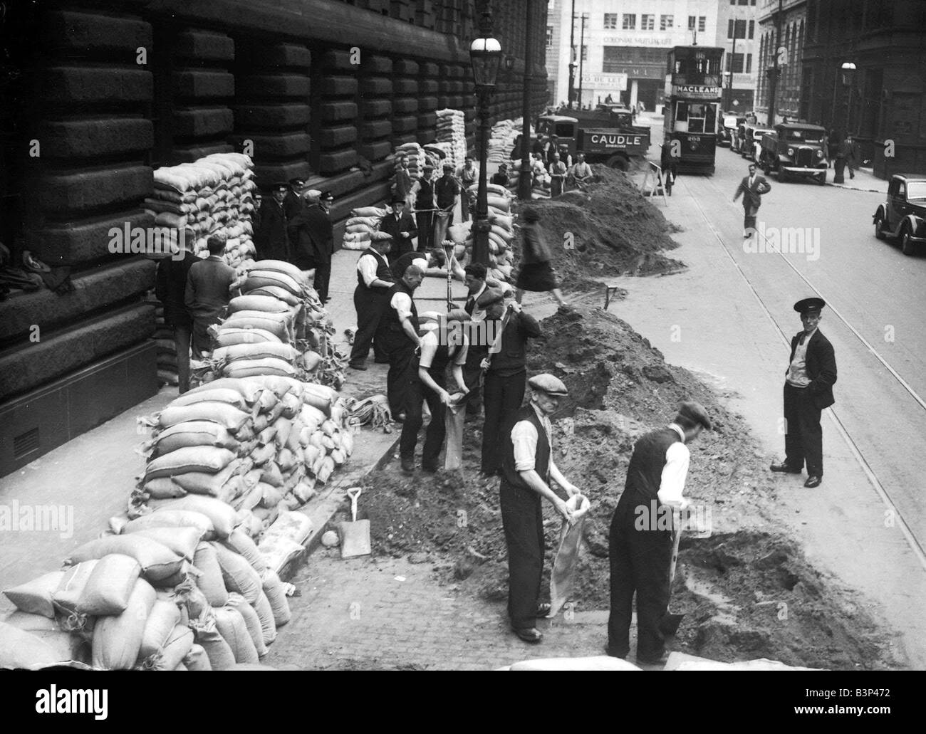 WW2 September 1939 Civilians filling sandbags lining the streets in a ...