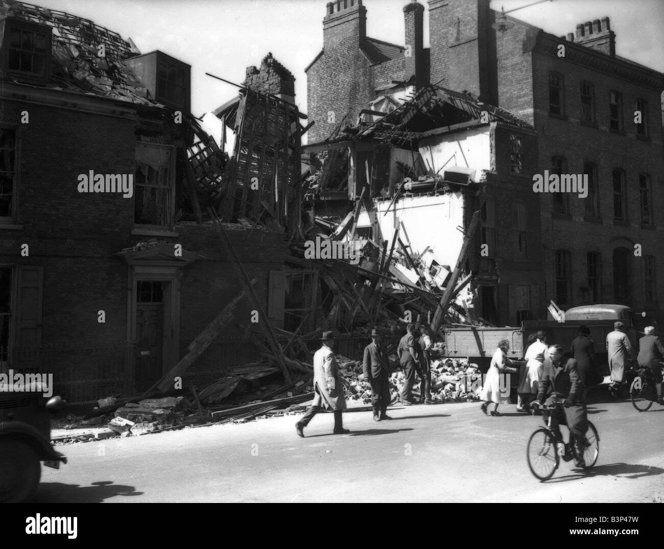 WW2 York Air Raid Bomb Damage Civilians walk pass bomb damaged housing ...