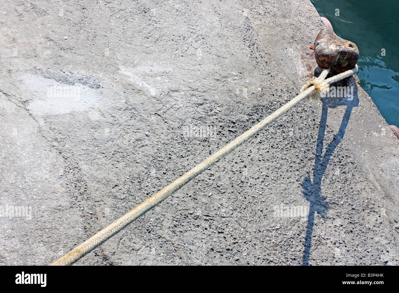 The mooring cable of a ship fastened in a port Stock Photo - Alamy