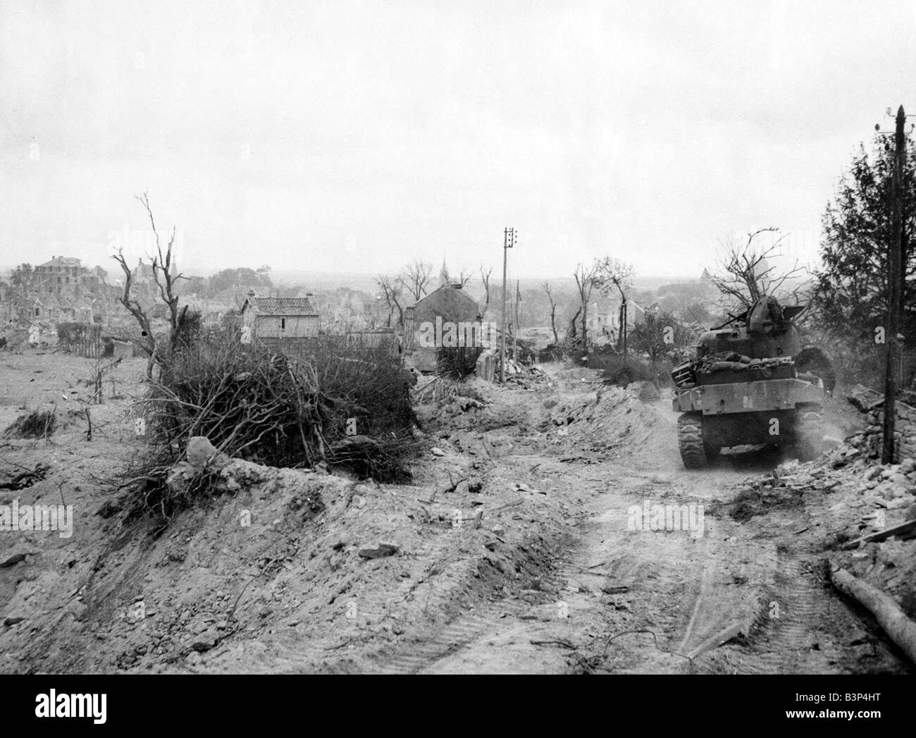 World War II Invasion of France A British army Sherman tank moves along ...