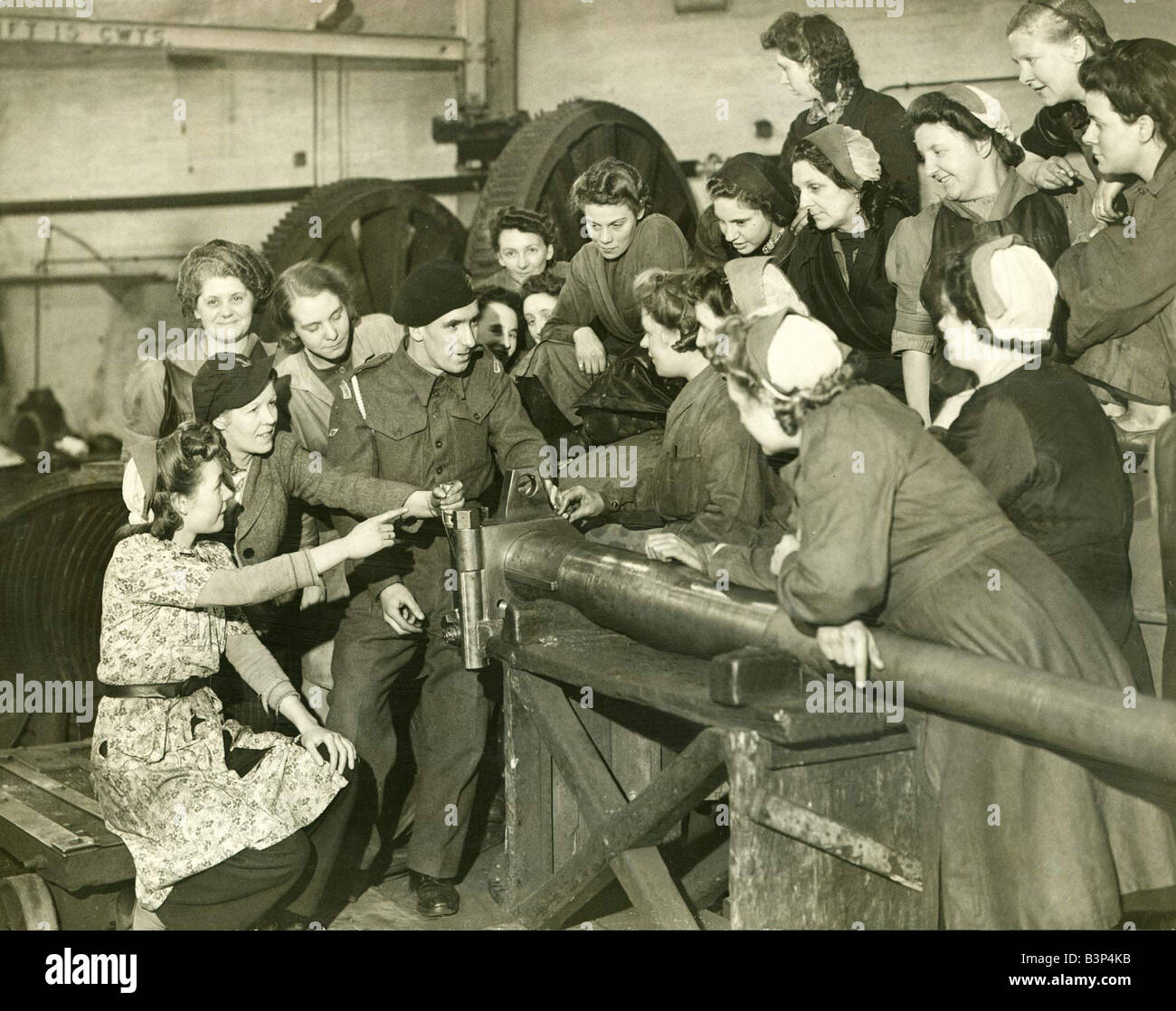 British trooper visits factory where the women make guns for his tanks ...