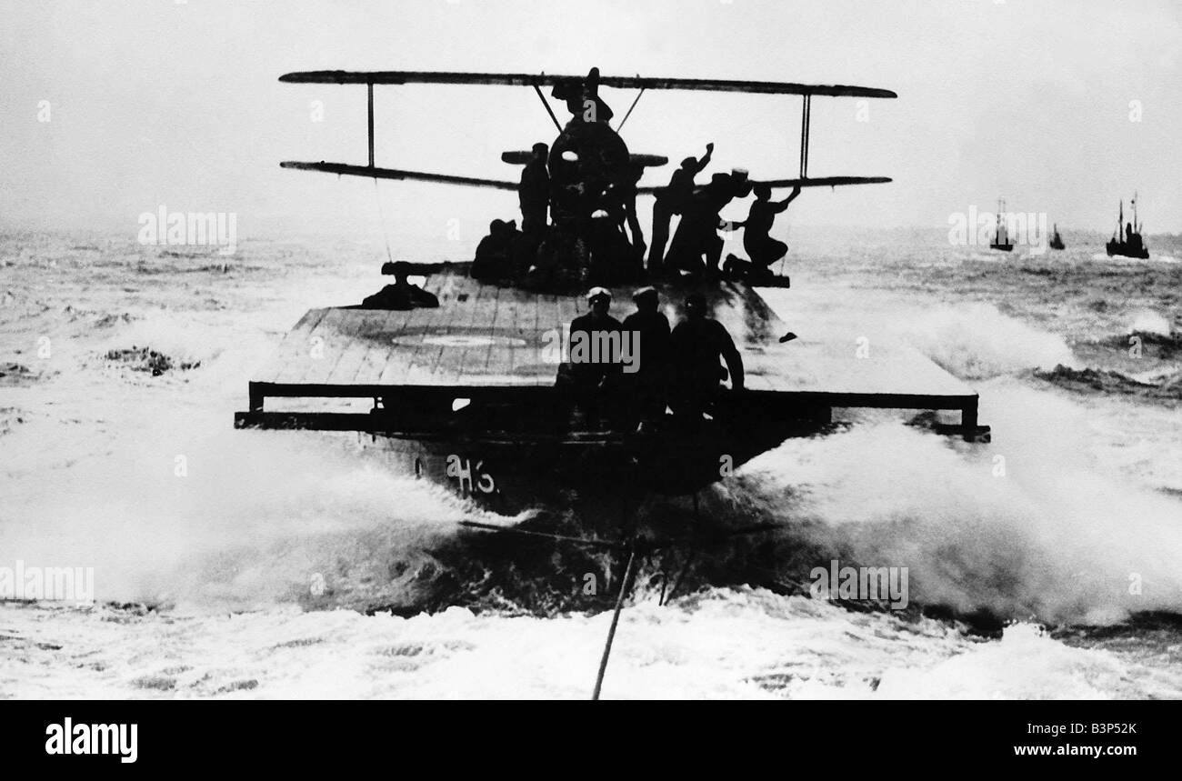 Small fighter plane under tow by fast destroyer Stock Photo - Alamy