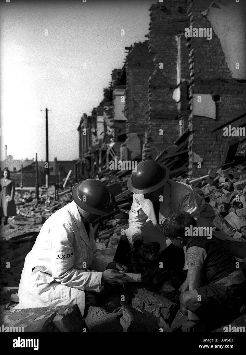 Rescue workers tending to wounded dog after air raid during WW2 Stock ...