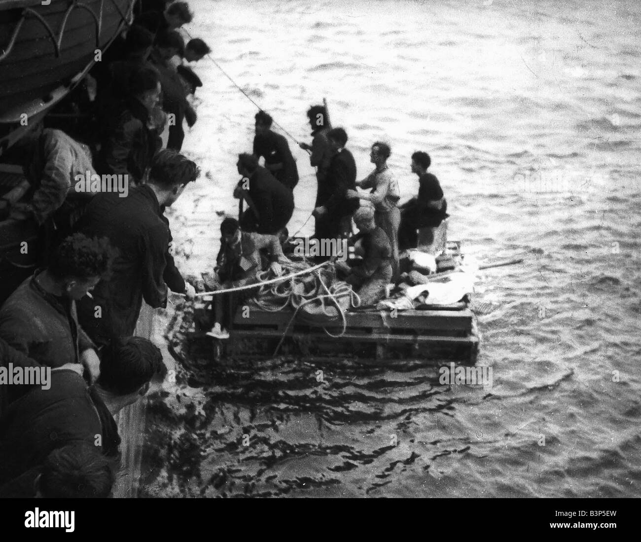 Ship picks up survivors from a raft during WW2 Stock Photo - Alamy