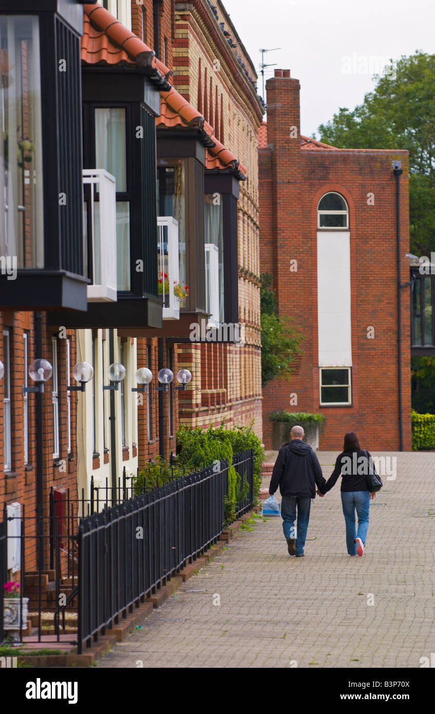 Couple walking hand in hand past townhouses on Bathurst Basin Bristol ...
