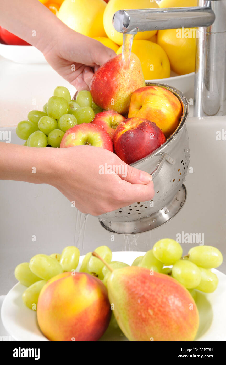 MAN WASHING FRESH FRUIT IN COLLANDER Stock Photo - Alamy