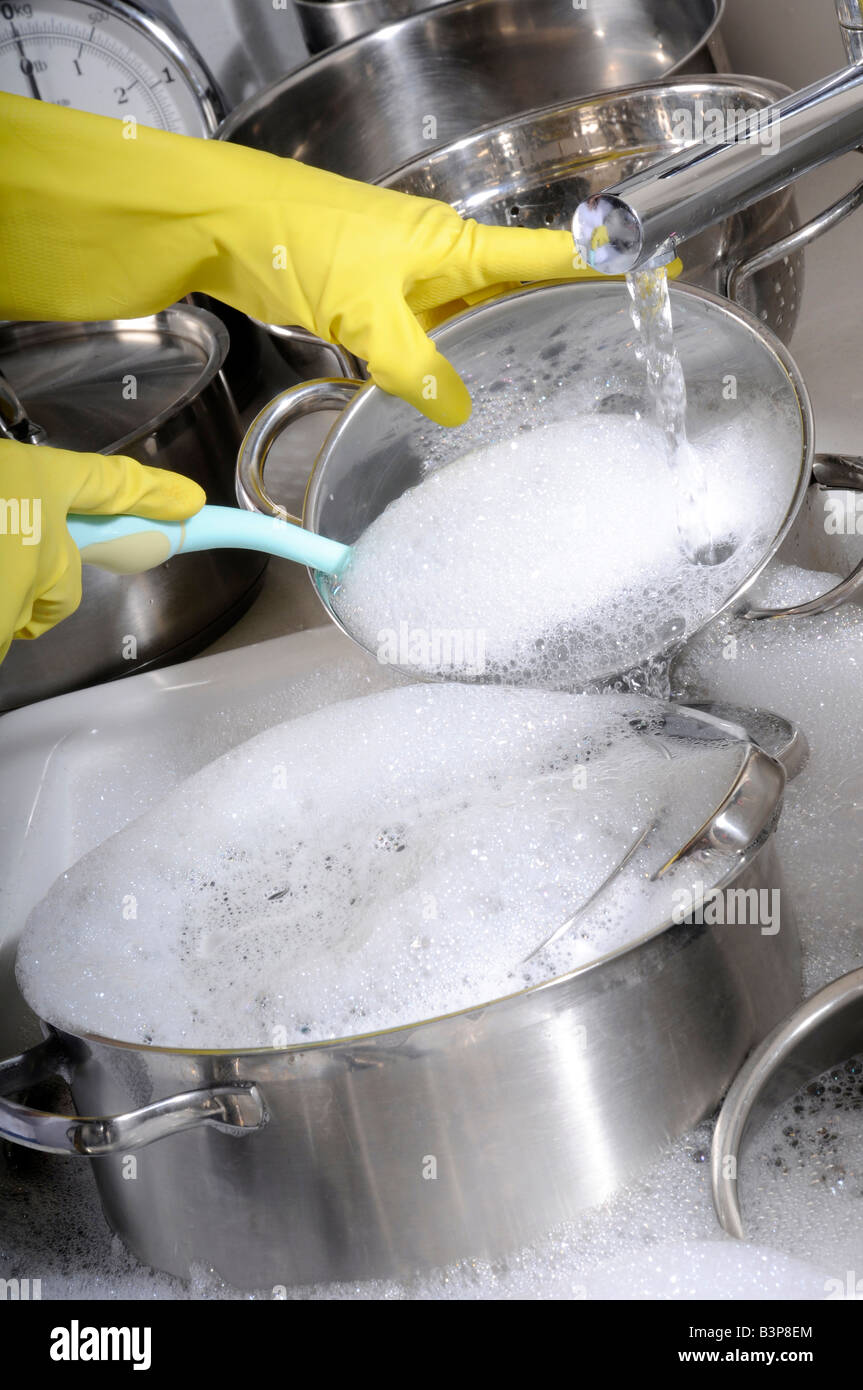 Washing pots pans wearing rubber hi-res stock photography and images ...