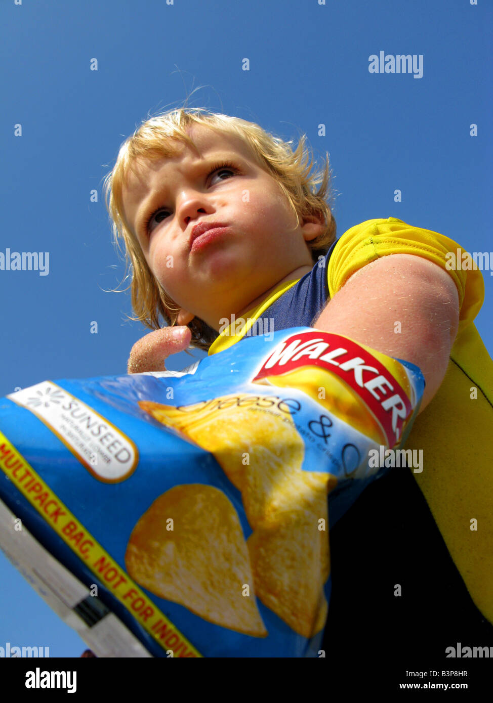 Child eating crisps Stock Photo - Alamy