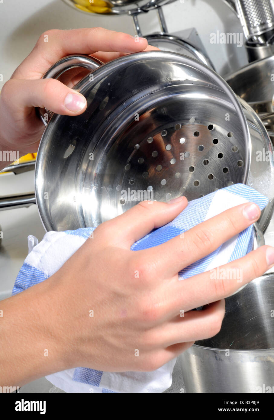 MAN DRYING POTS AND PANS Stock Photo - Alamy