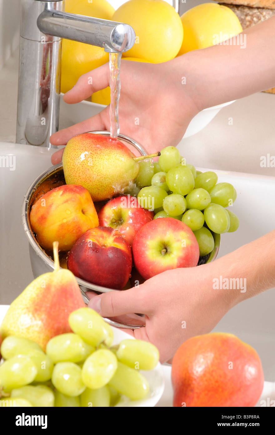 MAN WASHING FRESH FRUIT IN COLLANDER Stock Photo - Alamy