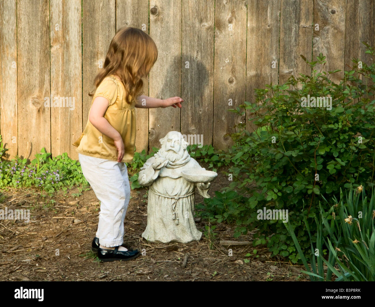 Little Girl with Statue Stock Photo - Alamy