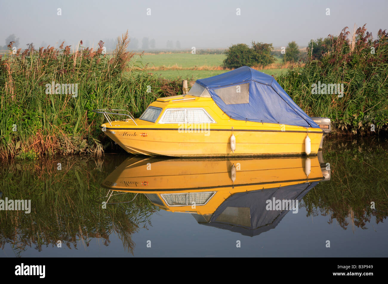 Yellow pleasure boat with reflection moored in Hardley Dike off the ...