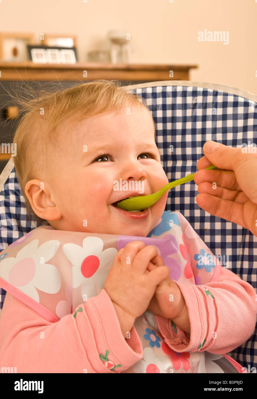 baby girl being spoon fed Stock Photo - Alamy