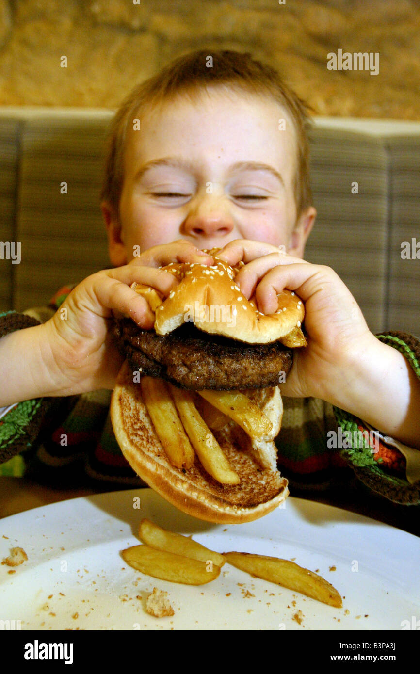 young boy eating junk food Stock Photo - Alamy