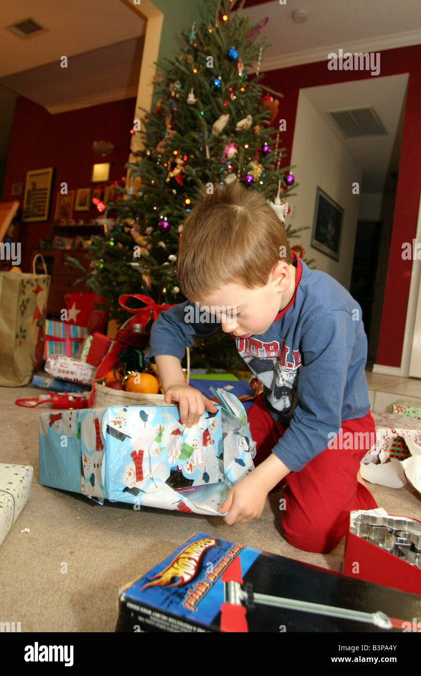 young boy opening presents on Christmas morning Stock Photo - Alamy