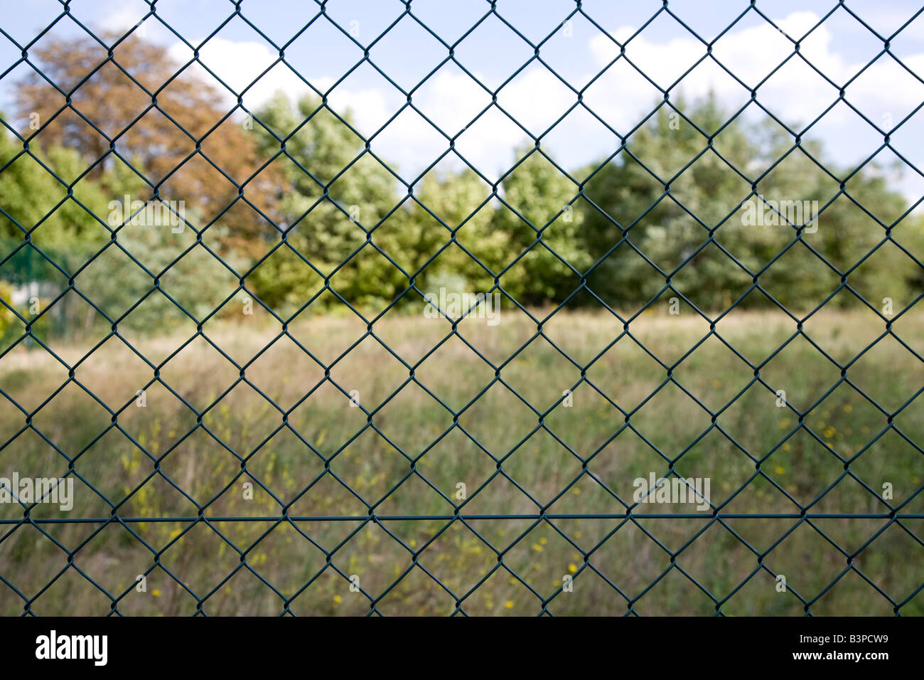 nature behind a wire fence Stock Photo - Alamy
