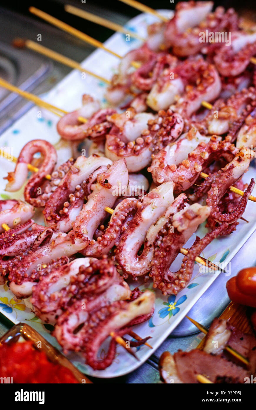 China, Hong Kong, Kowloon. Seafood skewers sit amongst trays of tasty ...