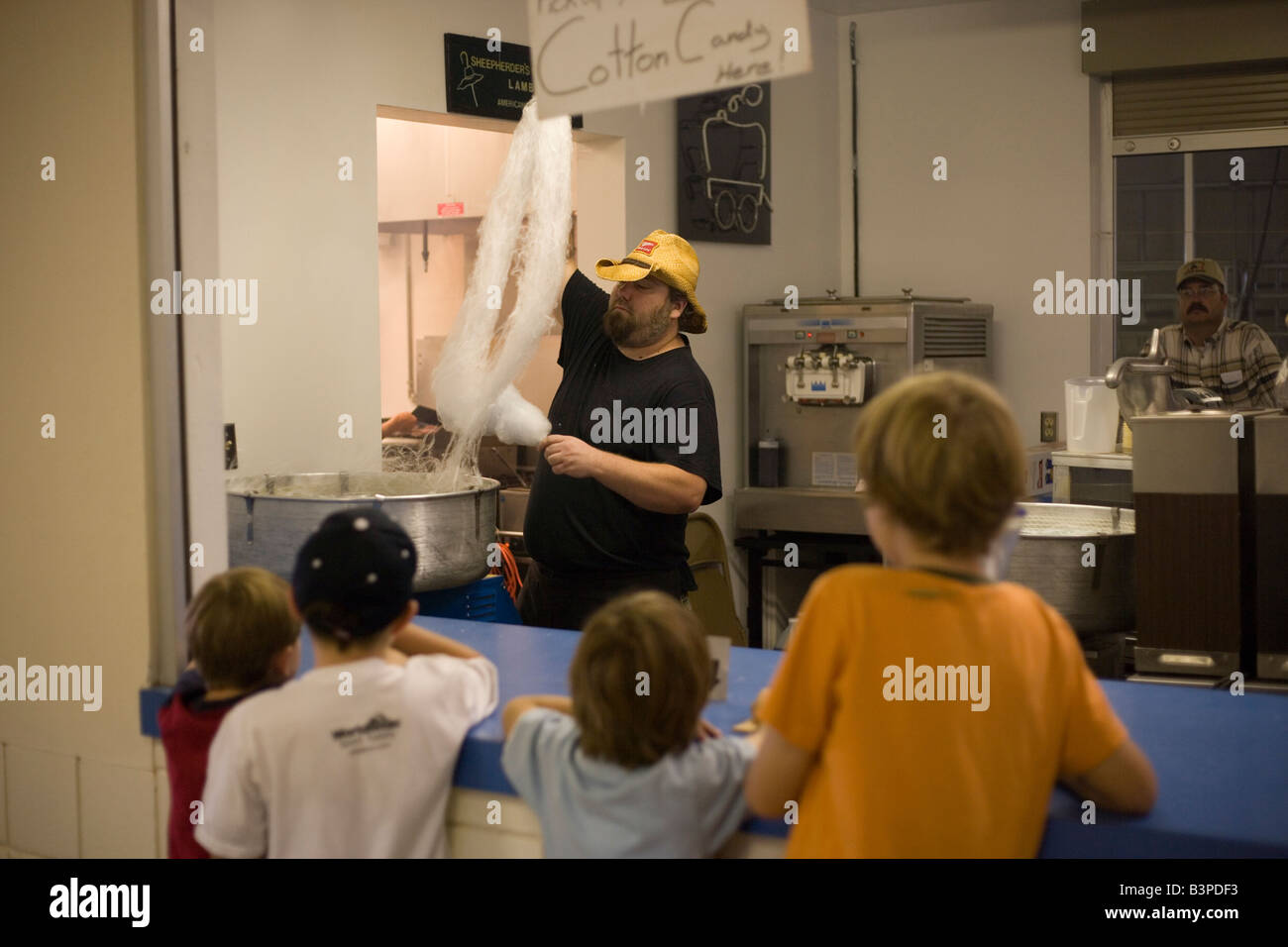 children watching man spinning cotton candy at New Mexico state fair ...