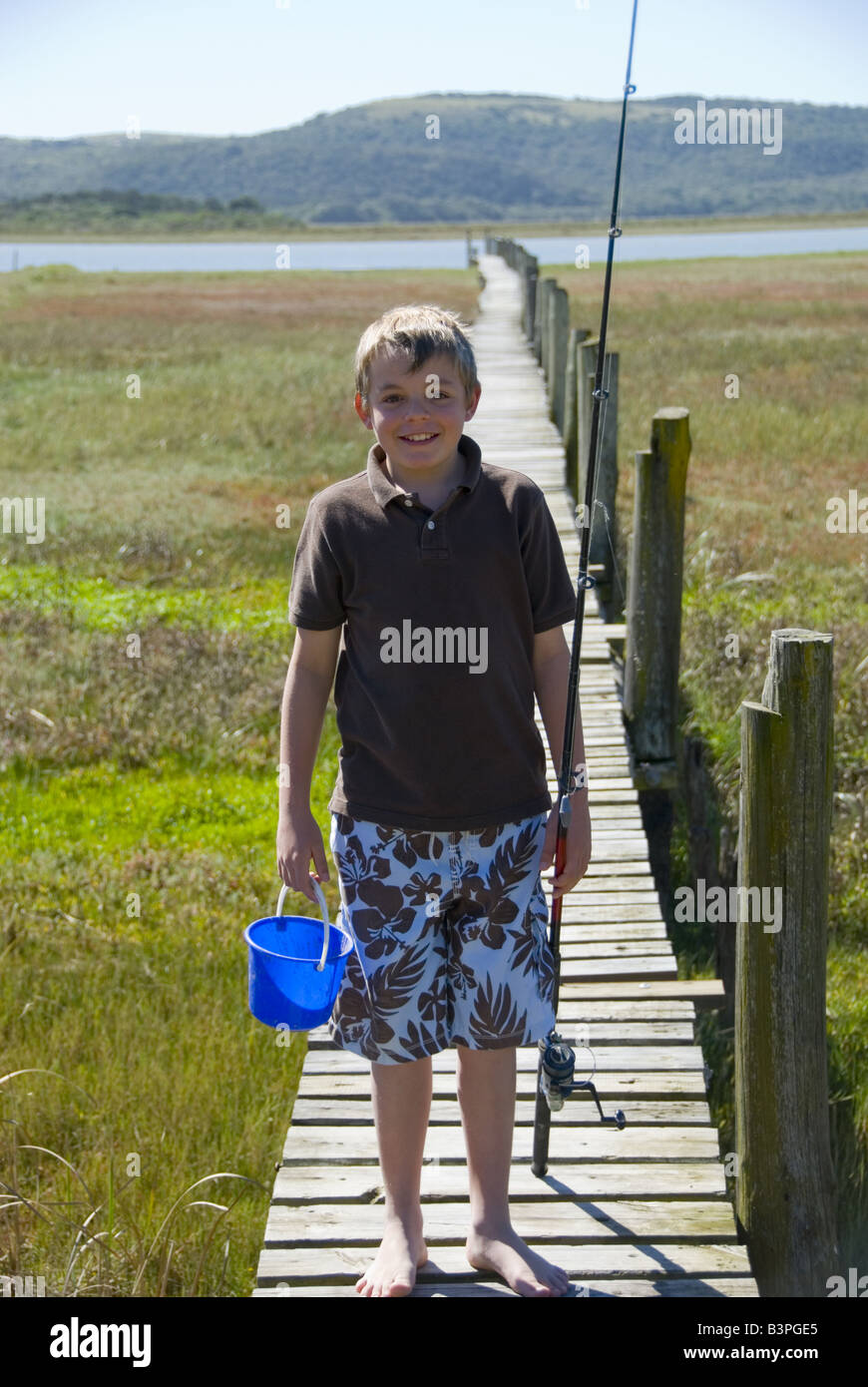 boy going fishing on jetty Stock Photo - Alamy