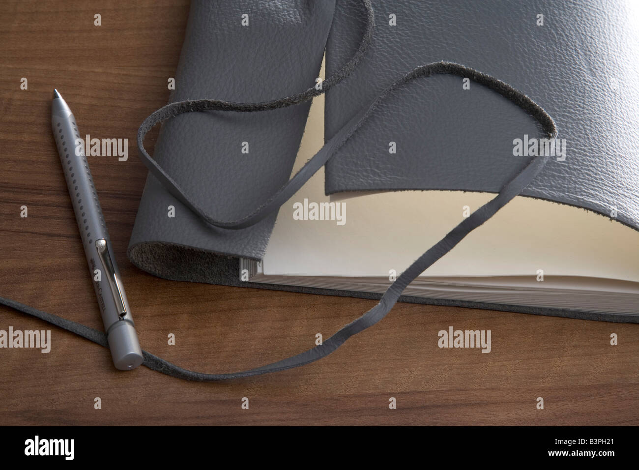 Half-open document folder with a pen lying on a desk Stock Photo - Alamy