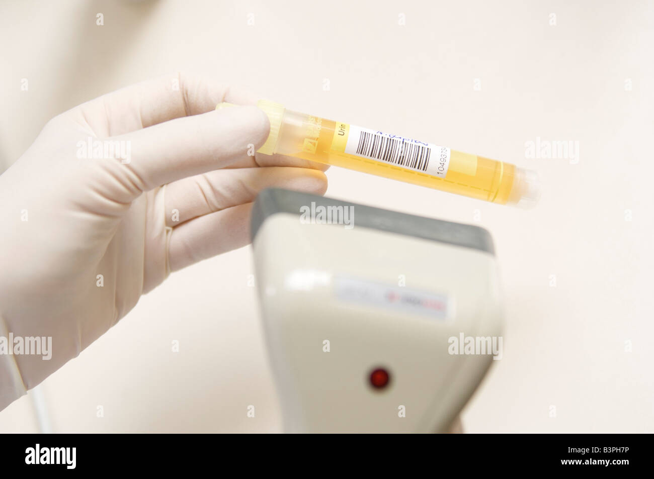 Laboratory assistant scanning the bar code of a patients blood specimen ...