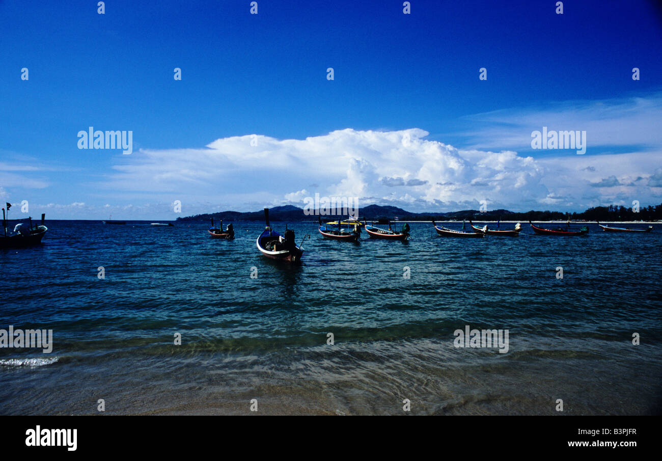 Fishing boats on the beach. Phuket Thailand. Blue water, blue sky ...