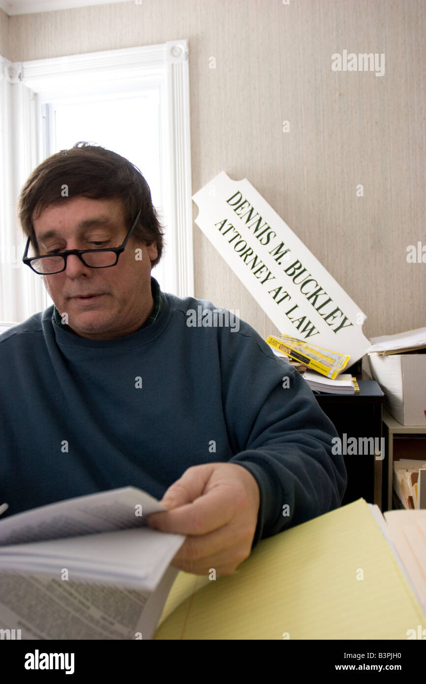 white male sitting at messy desk and computer with papers around him ...