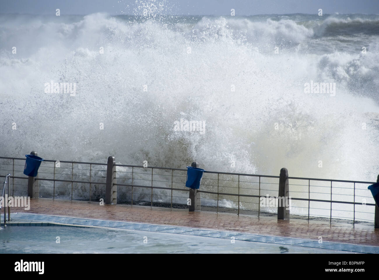 waves crash into poolside Stock Photo - Alamy