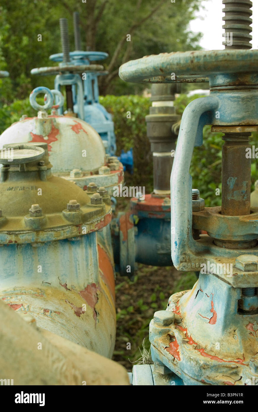 Old valves on water pipes rust and reveal many layers of hidden paint ...