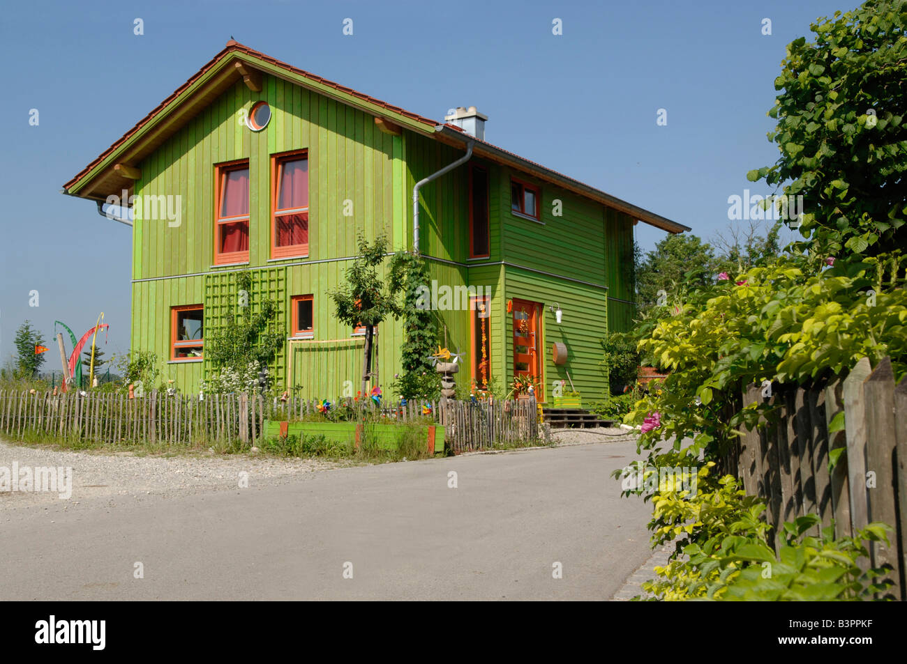 Modern, green wooden family house Stock Photo - Alamy