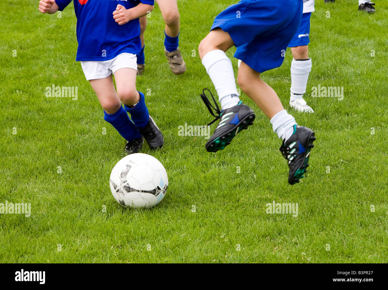 Close-up of players fighting for the ball in a soccer game for children ...