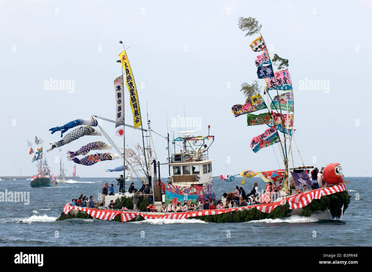 Fishing boat decked out in colorful banners and singing crew members ...