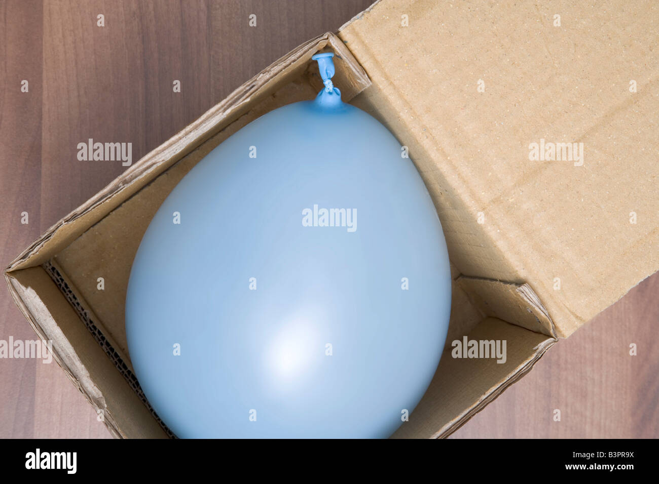Light-blue balloon in a cardboard box Stock Photo - Alamy