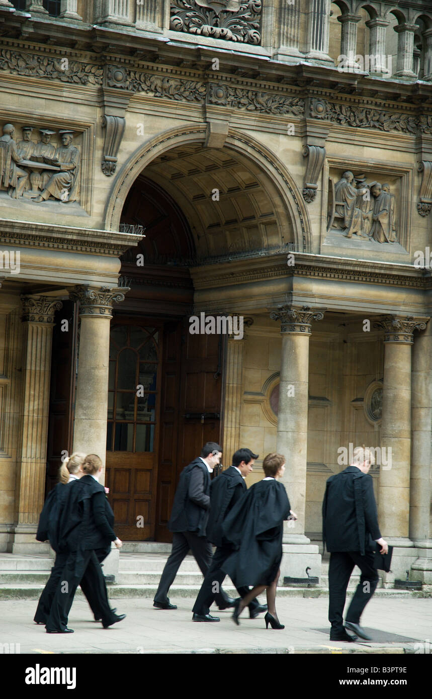 Oxford exam students dressed in suits and gowns and carrying ...