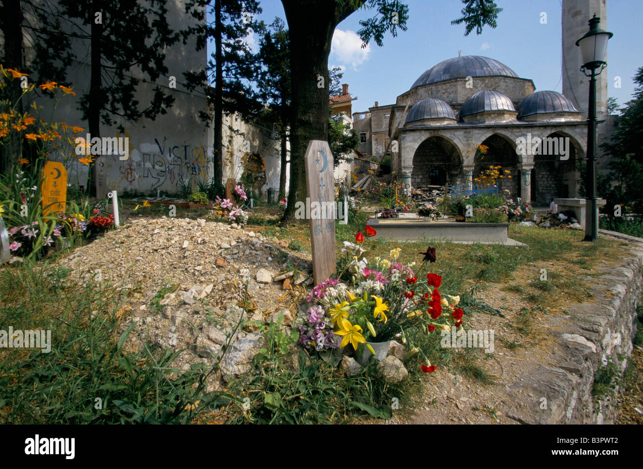 Mostar, june 1996', fresh flowers on the headstone of a grave in the ...