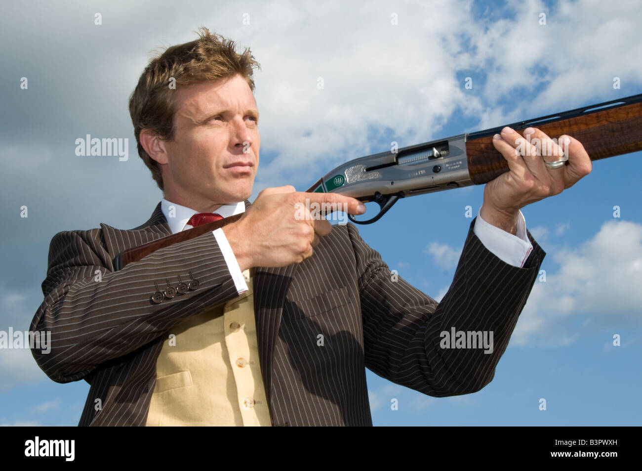 Business man golf club gun hi-res stock photography and images - Alamy