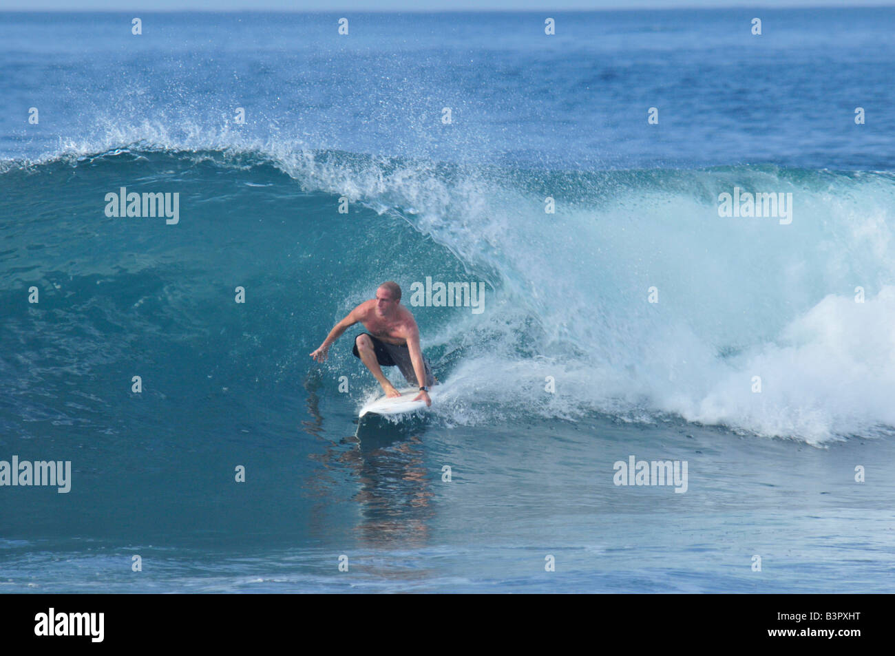 Surfer riding a wave, Kuta Beach, Bali, Indonesia Stock Photo - Alamy